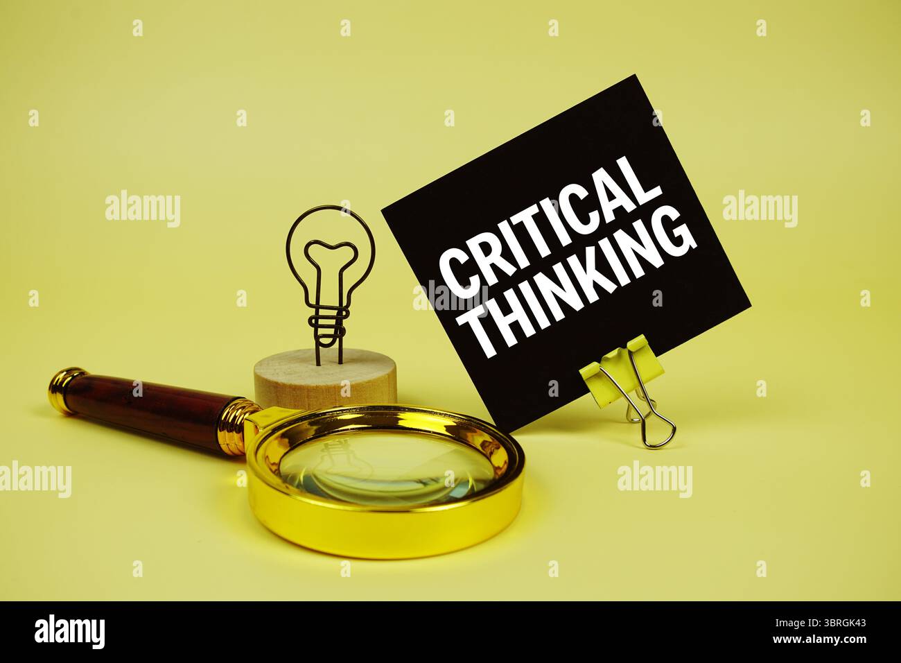 Critical Thinking text message on sticky note with magnifying glass on ...