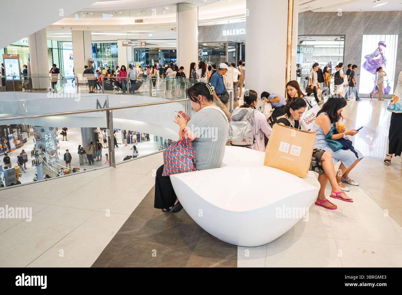 Bangkok, Thailand. 12th July, 2025. Shoppers take a break on a public ...