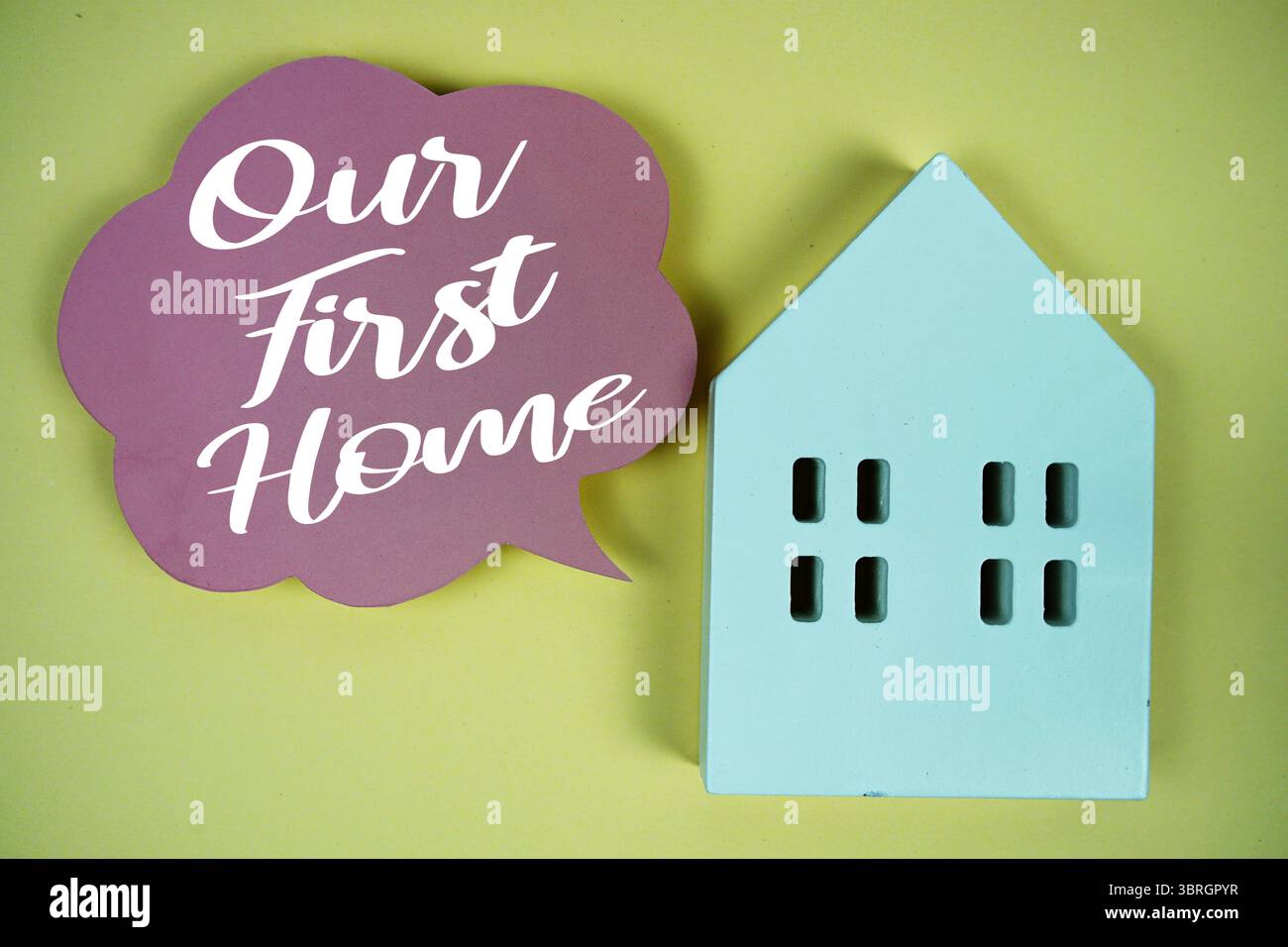Our First Home text with house model on yellow background Stock Photo ...
