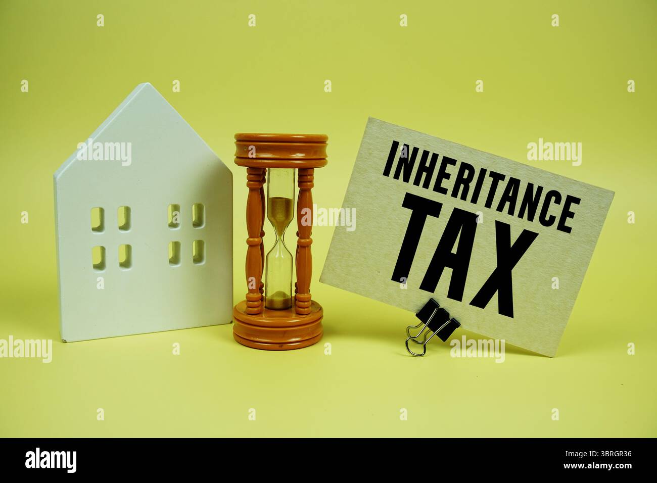 Inheritance Tax text with house model and houre glass background Stock ...