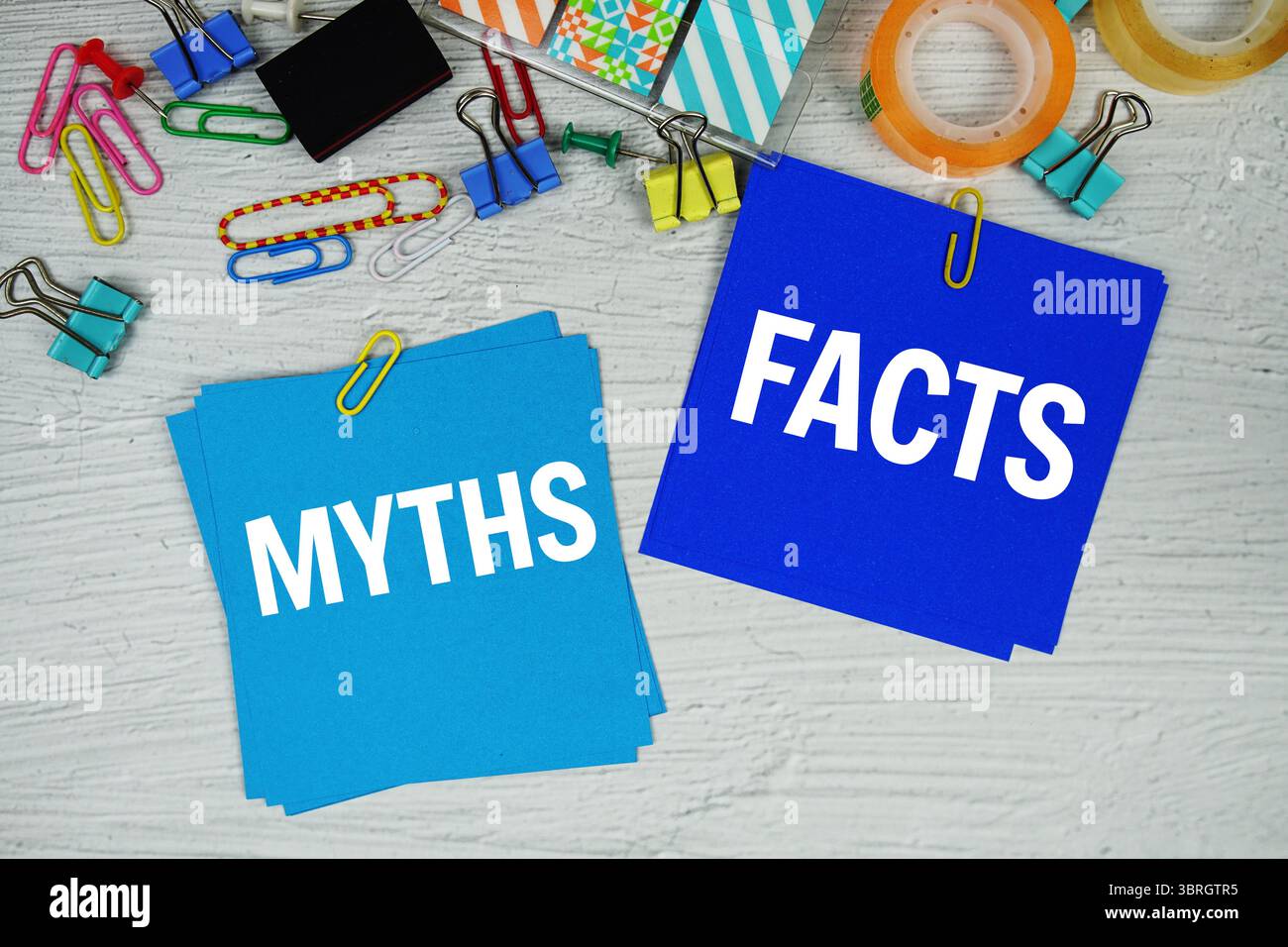 Myths vs Facts text on stick note with stationery on concrete ...