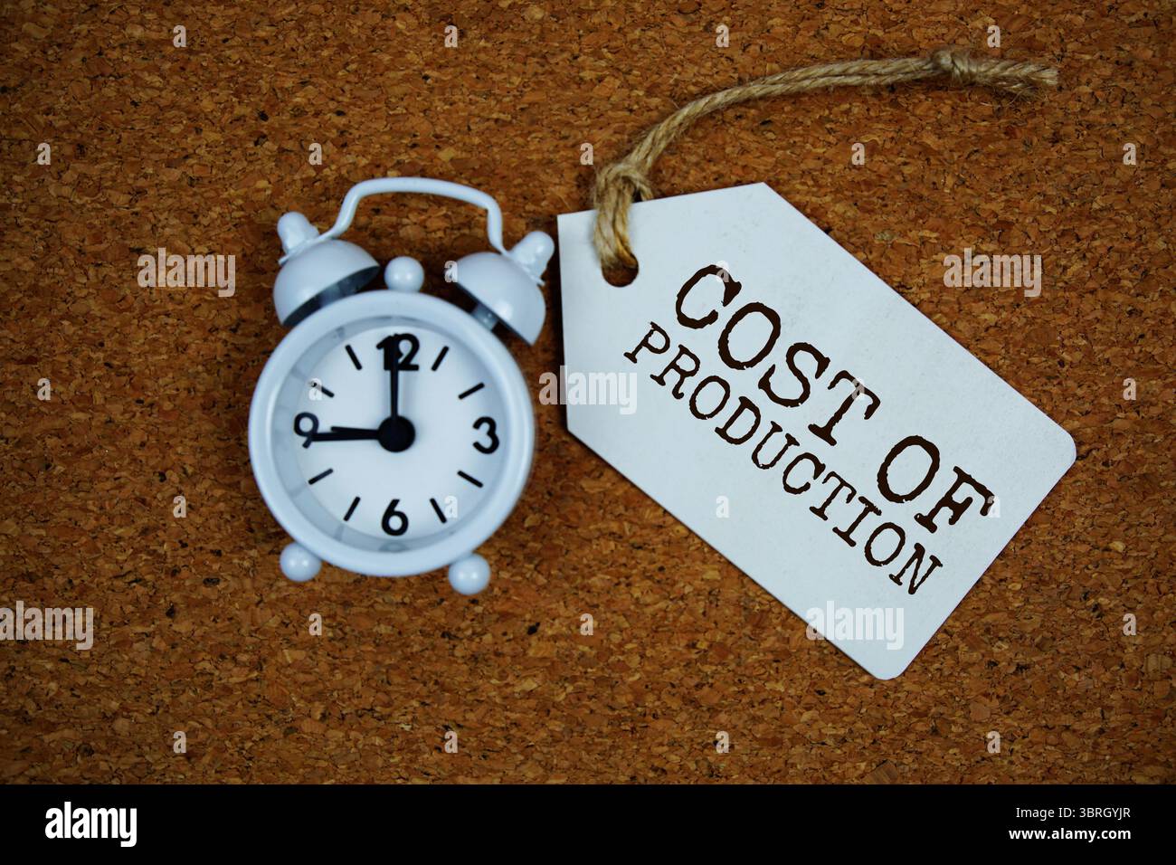 Cost Of Production text on price tag with alarm clock on cork board ...