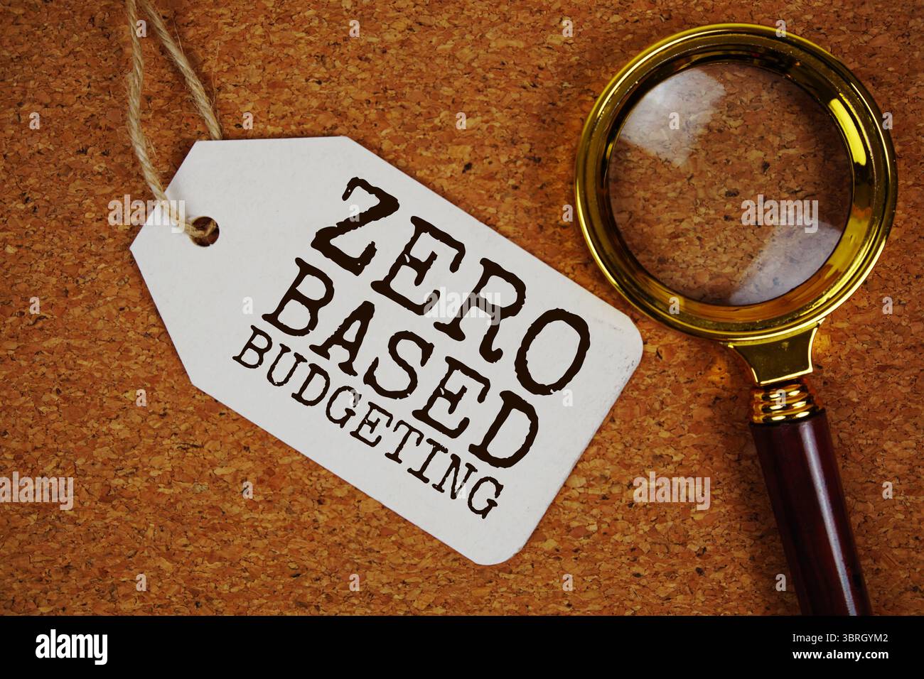 Zero Based Budgeting text on price tag with magnifying glass on cork ...