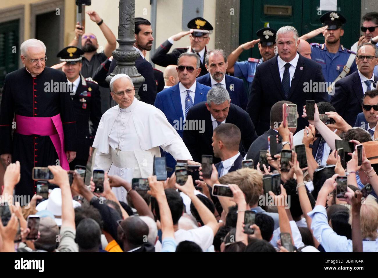 Pope Leo XIV waves to faithful as he arrives to celebrate a mass inside ...
