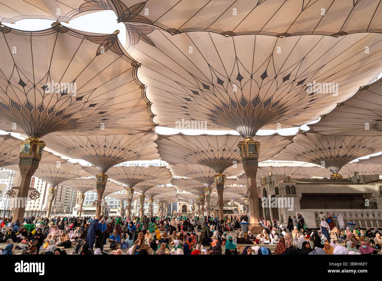 Medina, Saudi Arabia - December 18, 2024: Pilgrims under giant ...