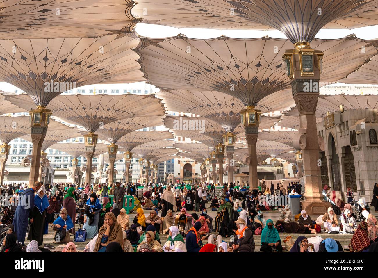 Medina, Saudi Arabia - December 18, 2024: Pilgrims under giant ...