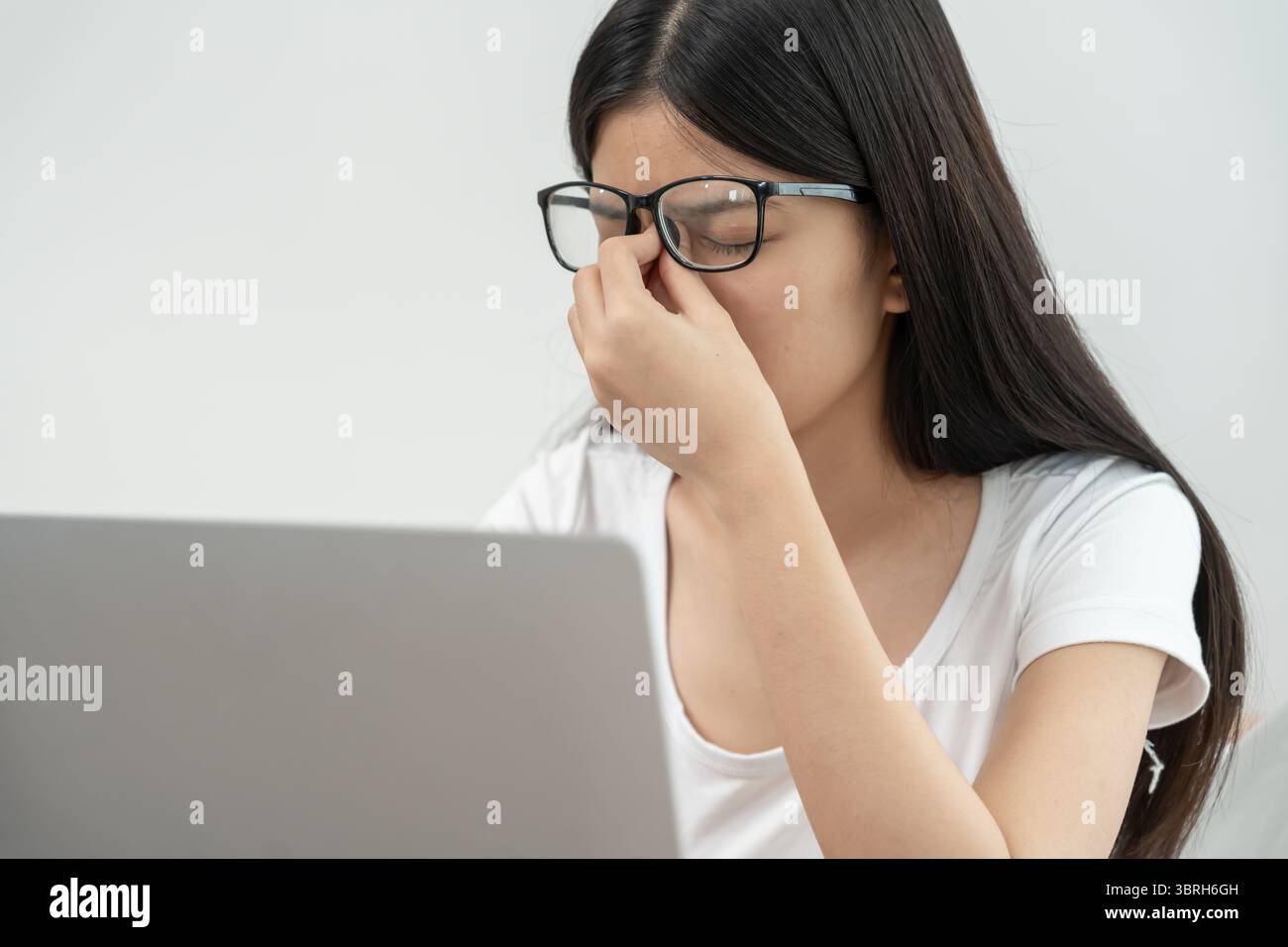 Eye problems, Asian women with tired and irritated eyes, eye rubbing ...