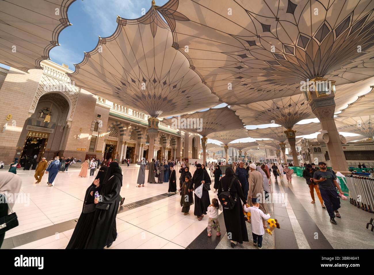Medina, Saudi Arabia - December 18, 2024: Pilgrims under giant ...