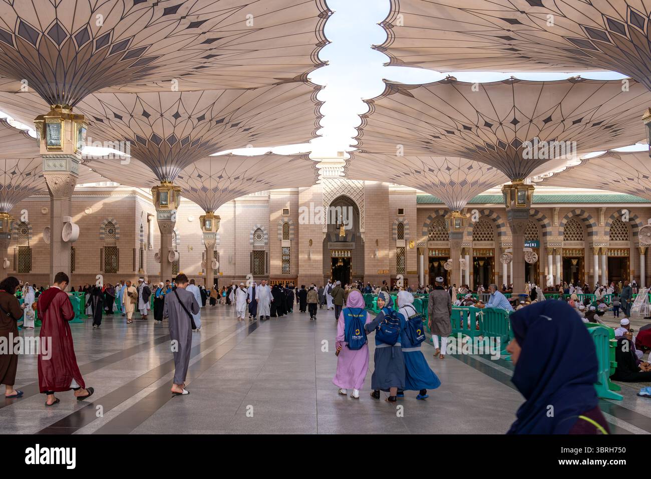 Medina, Saudi Arabia - December 18, 2024: Pilgrims under giant ...