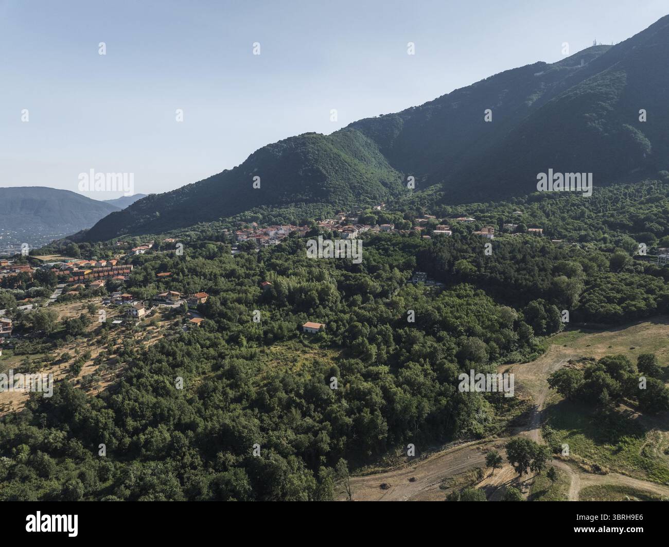 Aerial view of a town nestled among verdant hills and valleys, a ...