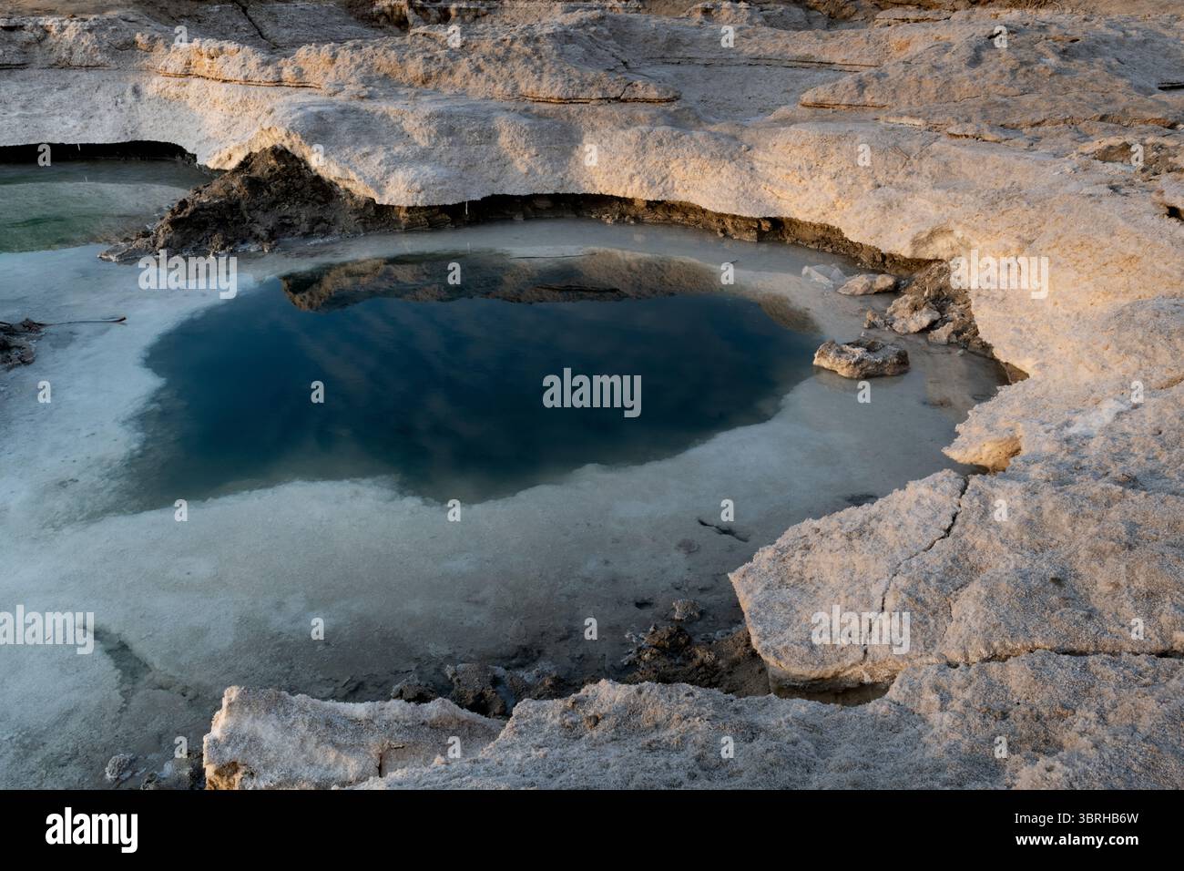 Colorful salt pool formed by erosion and evaporation on the shoreline ...