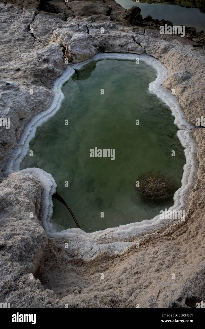A colorful, green salt pool formed by erosion and evaporation on the ...