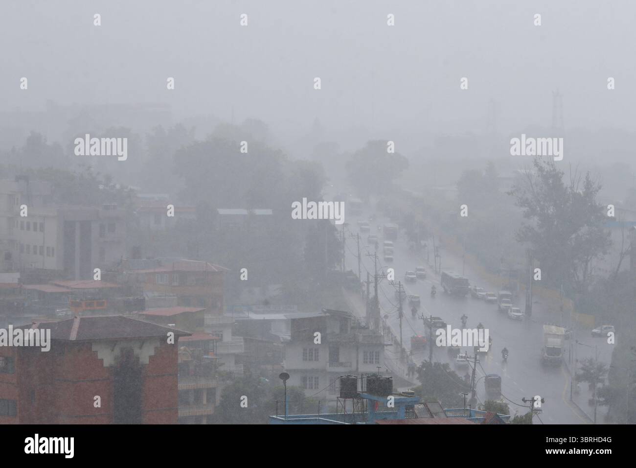 On July 13, 2025, in Kathmandu, Nepal. Vehicles rush amidst the rainy ...