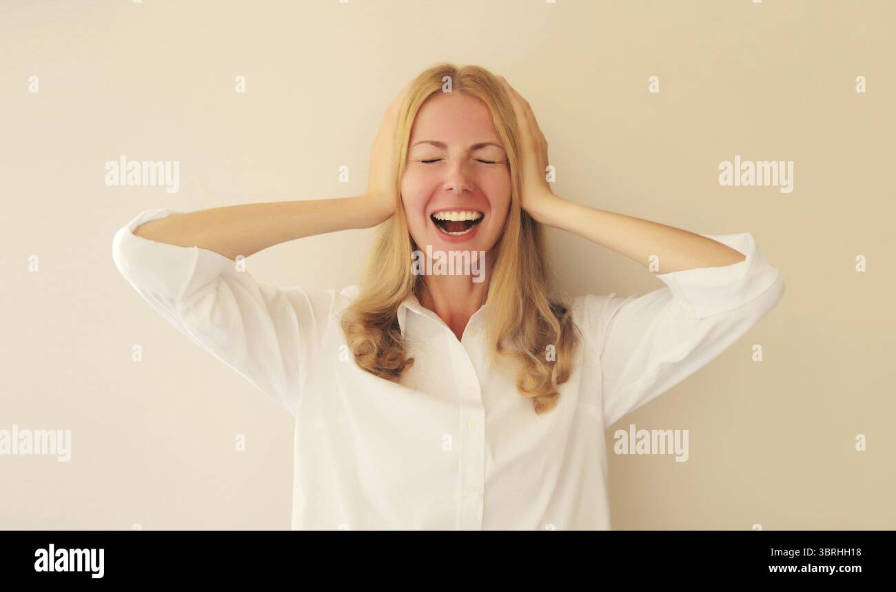 Exhausted tired caucasian young woman employee screams with headache or ...