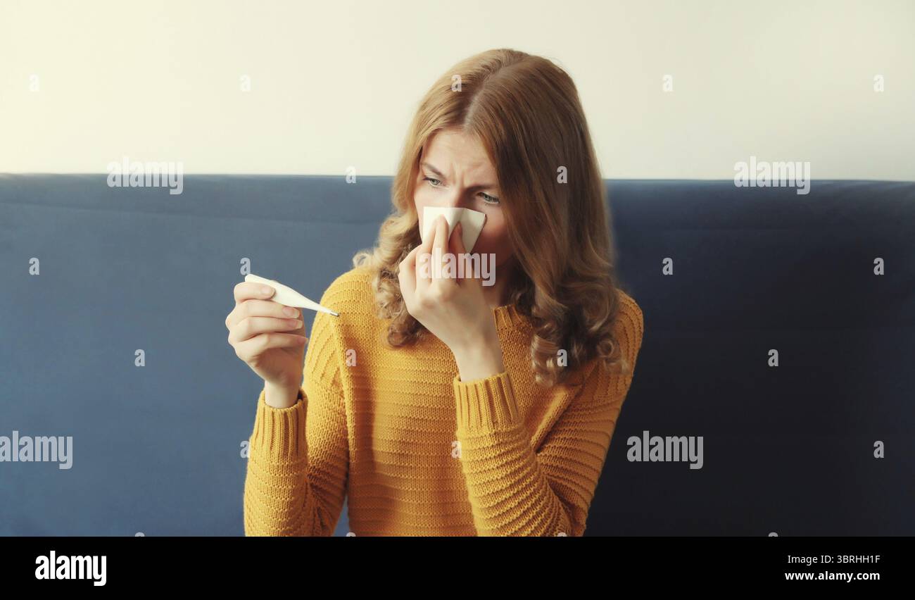 Sick exhausted woman sneezing blow nose using tissue and measuring ...