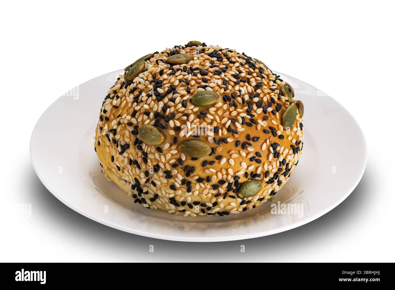 Single homemade burger bun topped with sesame and pumpkin seeds in ...