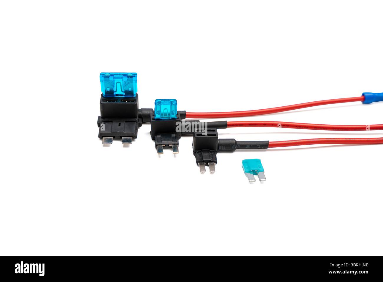 Three types of fuse taps with blue blade fuses are aligned side by side ...