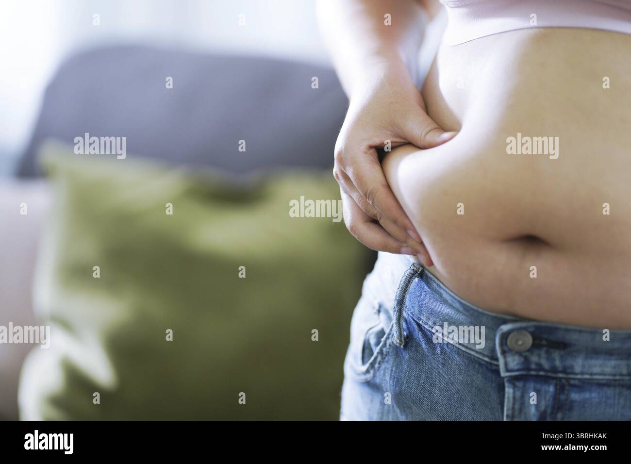 Obese Woman with fat upset about her belly. Overweight woman touching ...