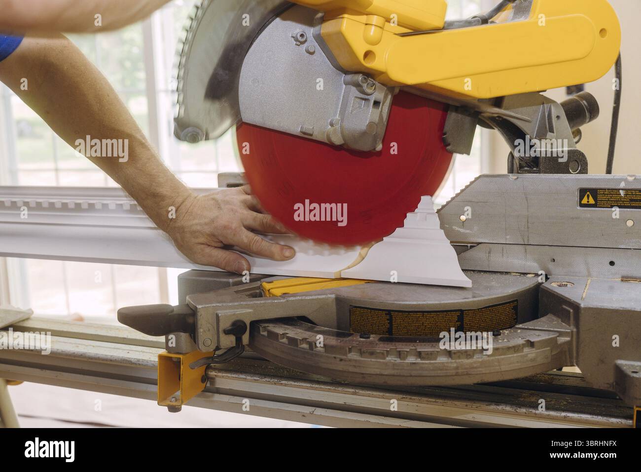 Cutting crown moulding for renovation new house under construction ...