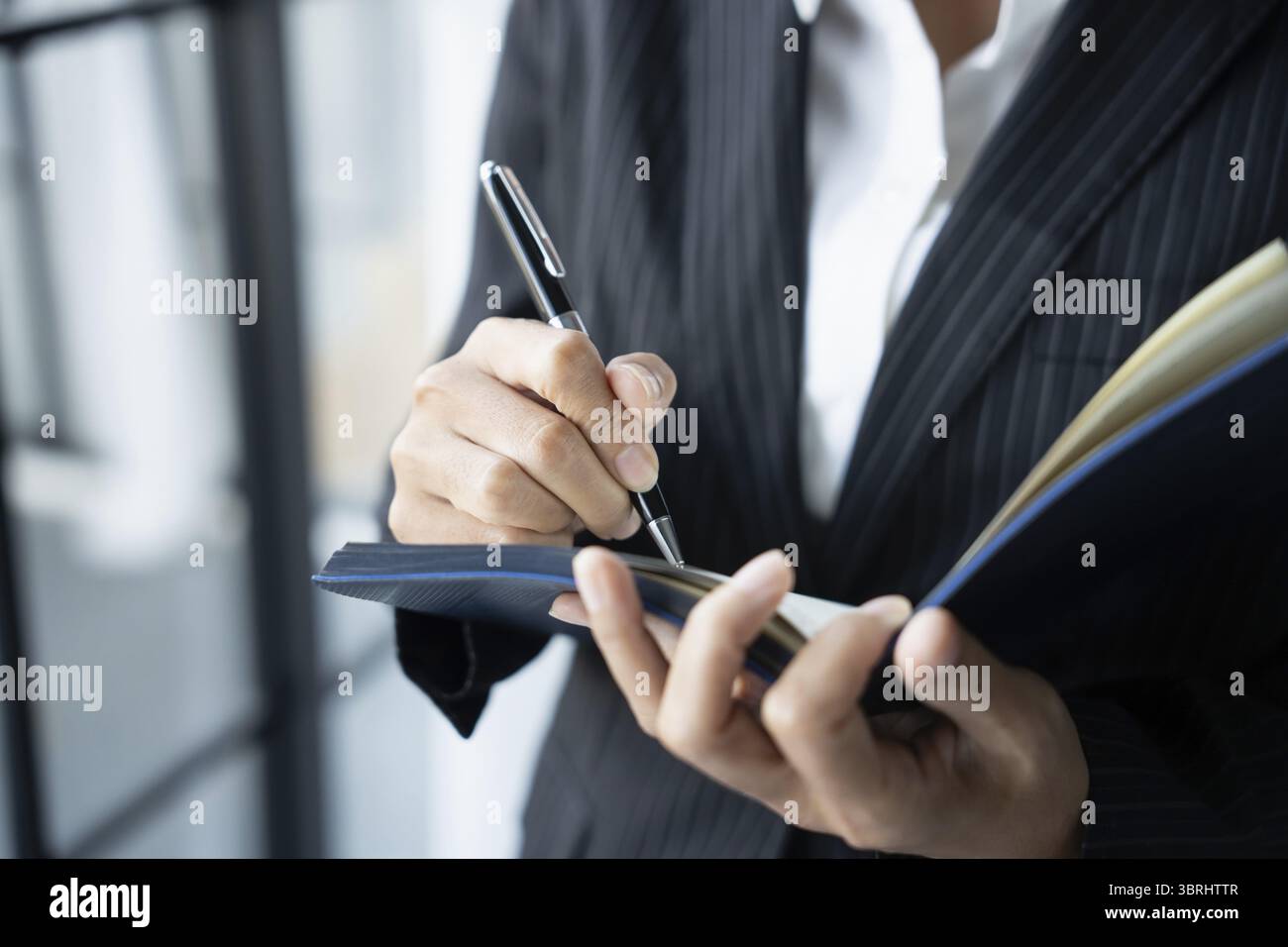 Business woman working from office taking reading and writing notes in ...