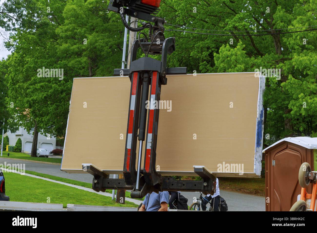 Forklifts in the construction of a built home under construction build ...
