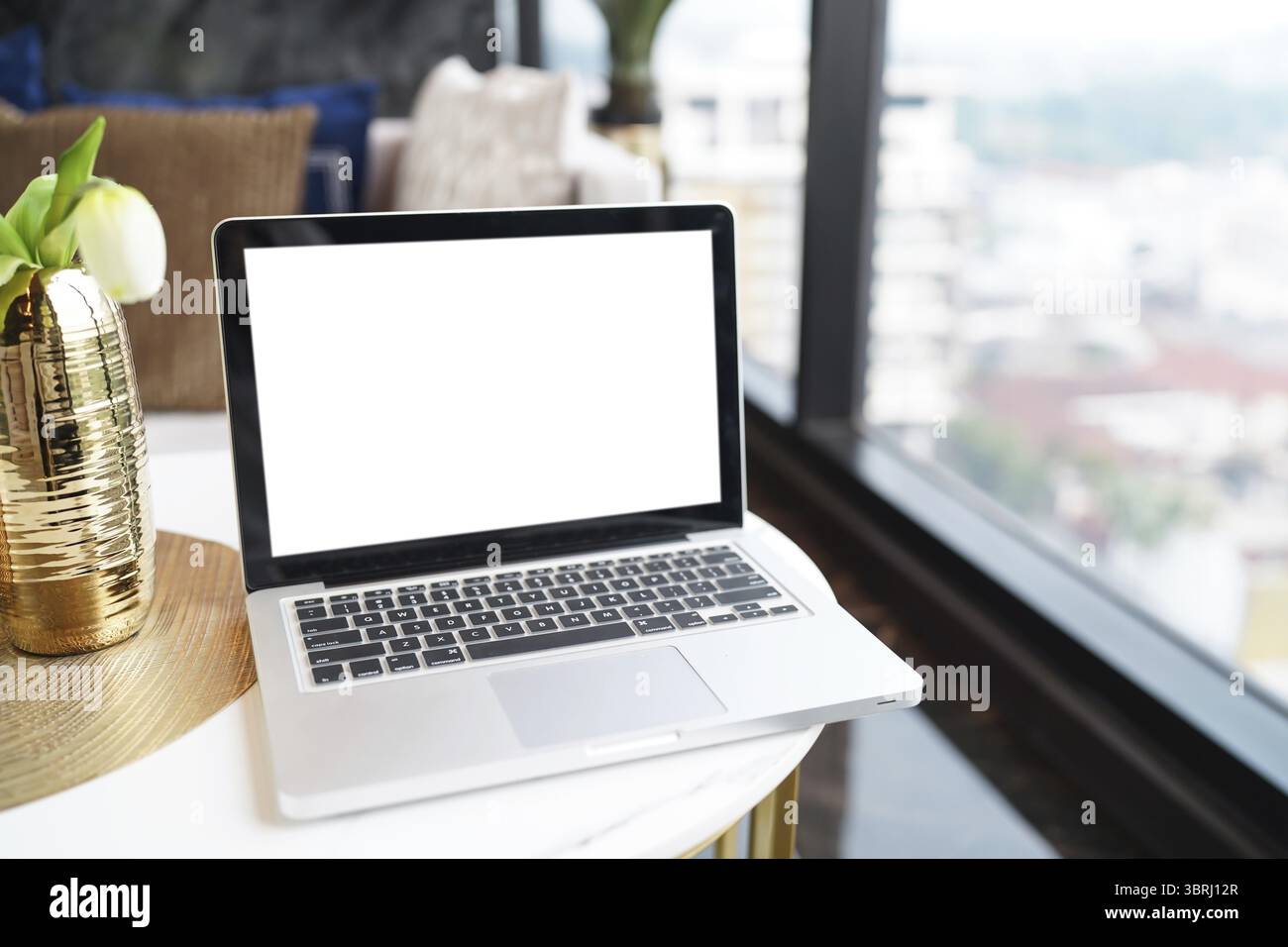 Laptop with Mock up blank screen on table in front of cafe space for ...