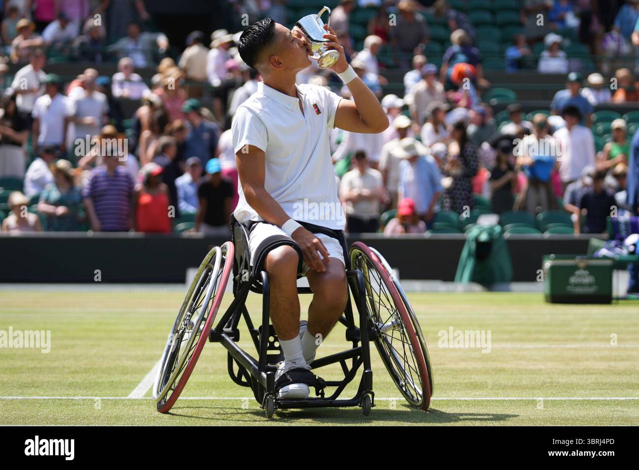 Tokito Oda of Japan kisses the trophy after winning the men's ...