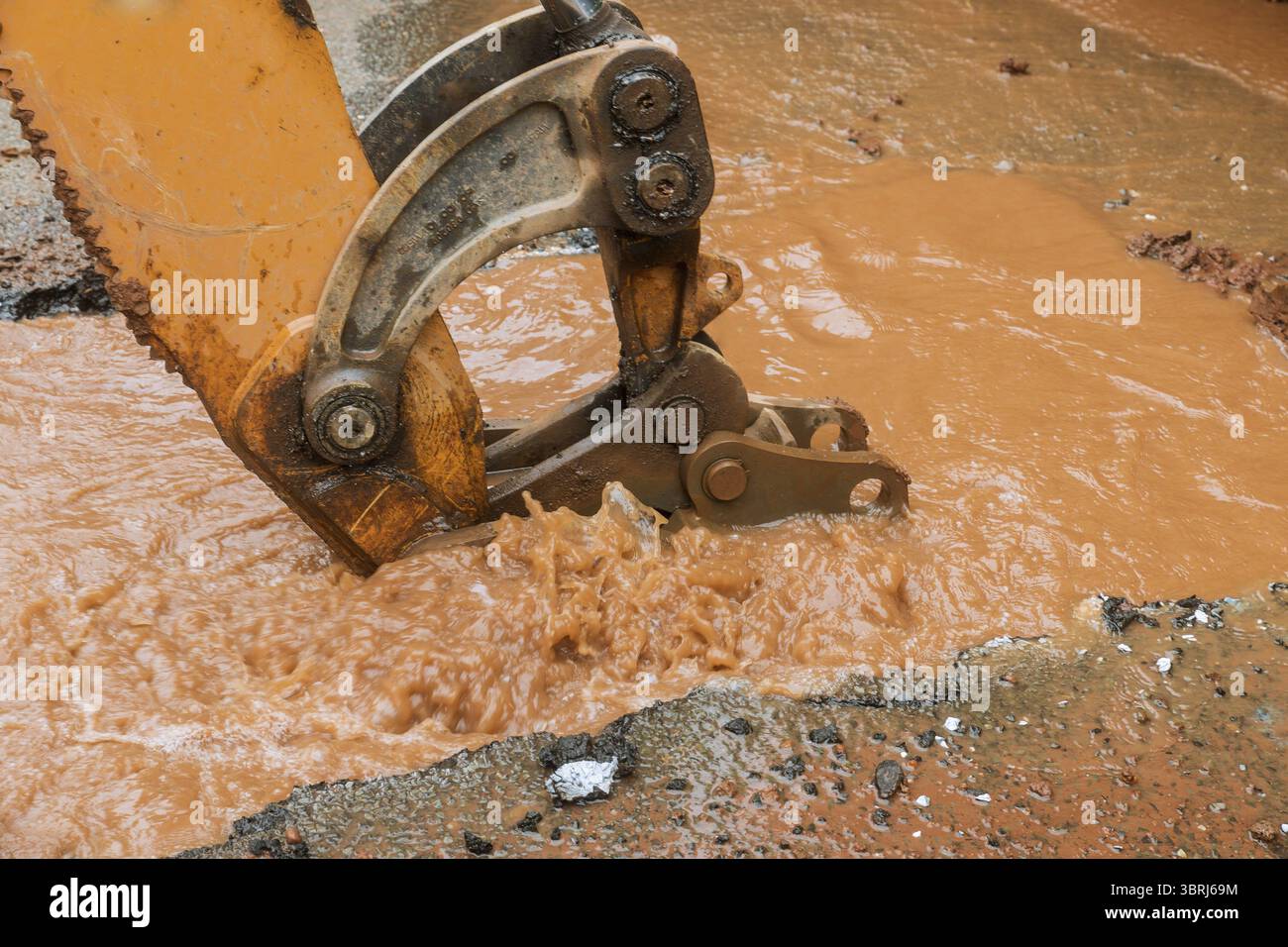 Water pipe break, leaking from hole in a road, pipe burst is repaired ...