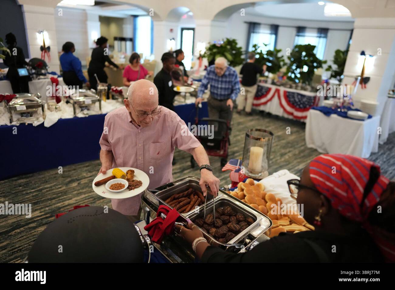 Dining room staff serve up an Independence Day buffet to residents, in ...