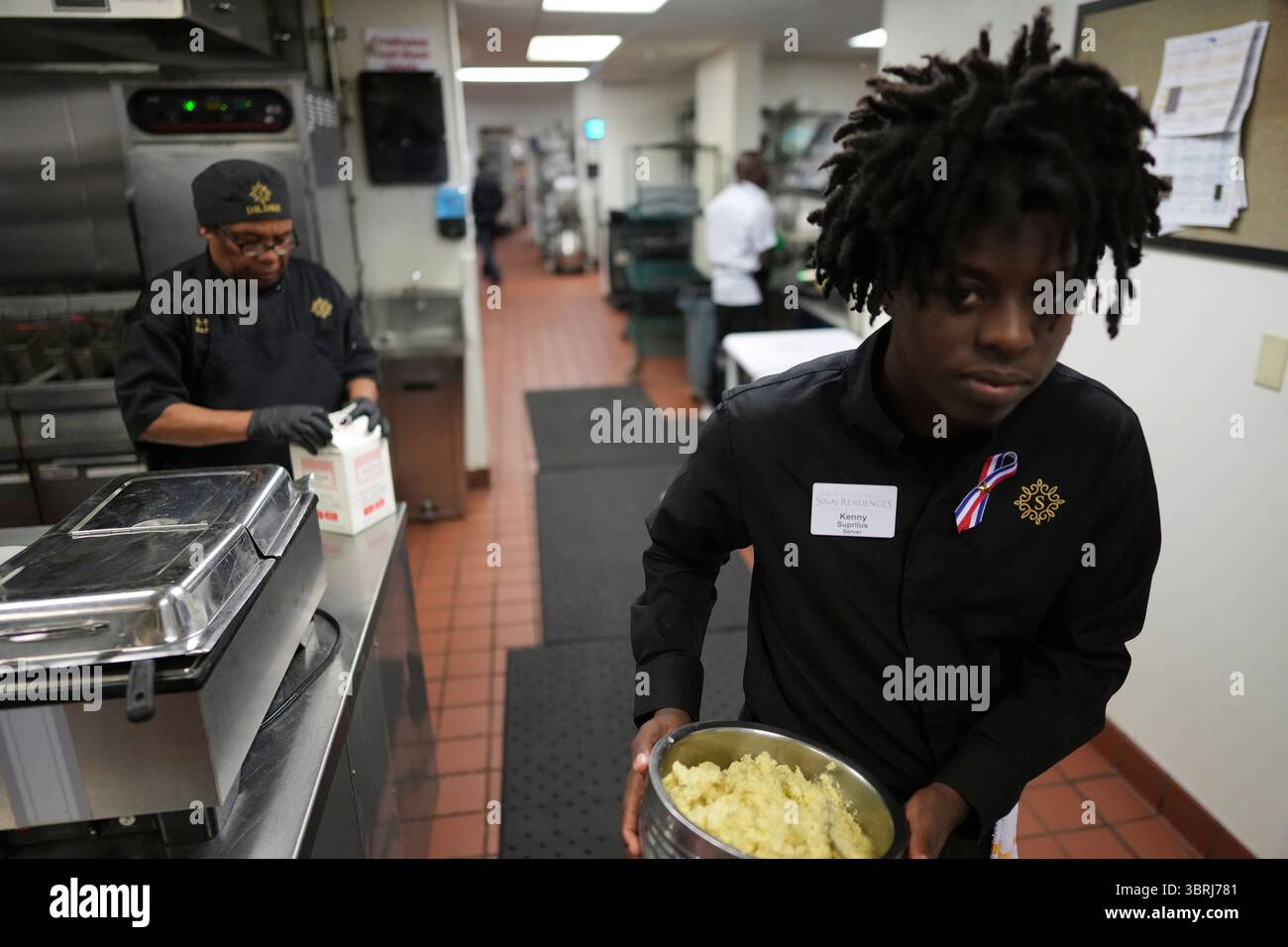 Dining room and kitchen staff work during an Independence Day buffet ...