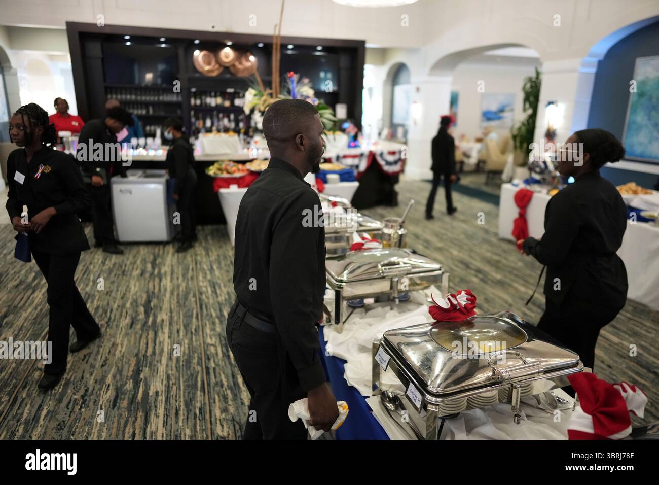 Dining room staff prepare for the opening of an Independence Day buffet ...
