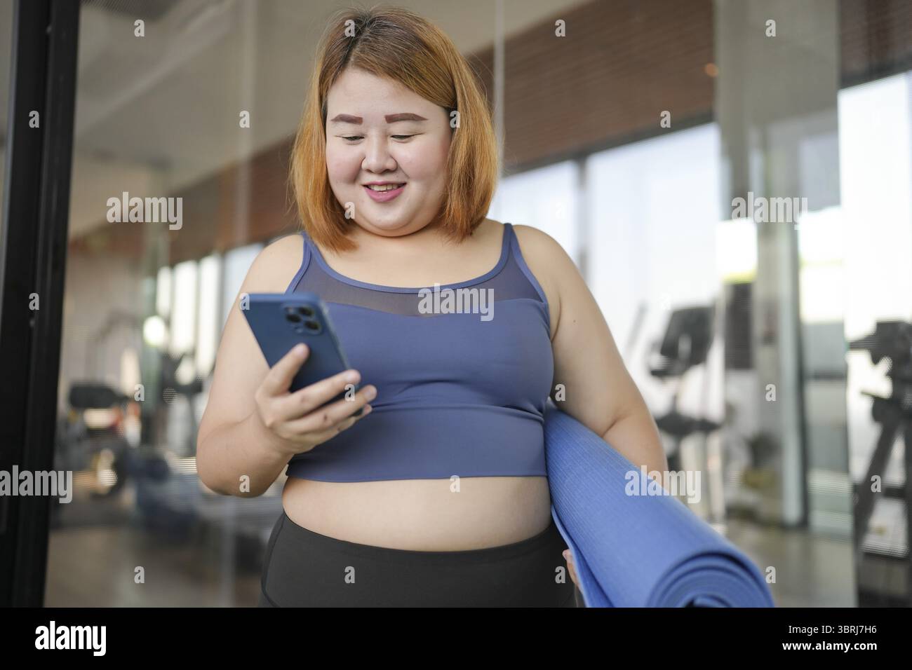 Obese asian woman diet holding yoga mat for training yoga exercising ...