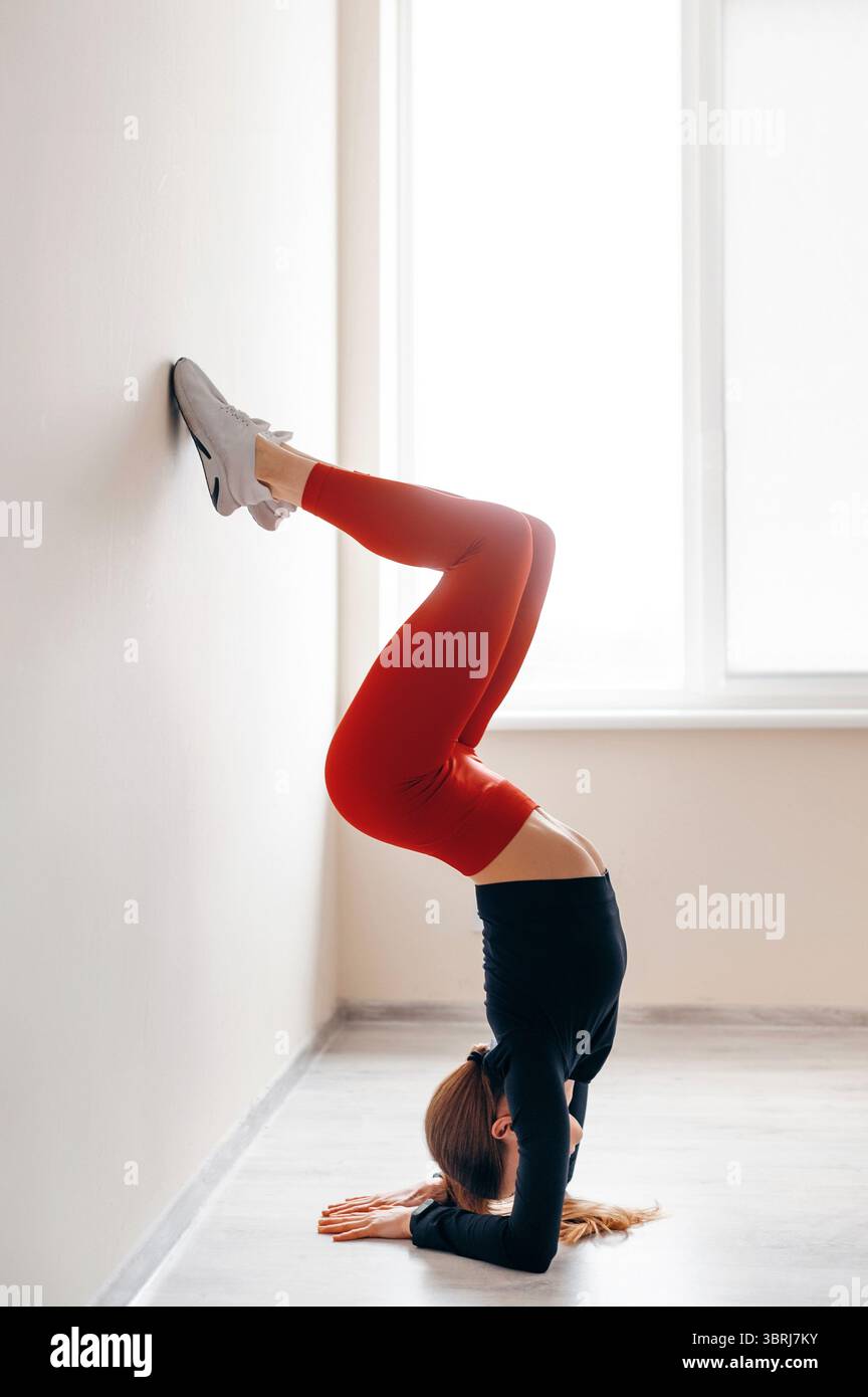 Strong woman with athletic body shape doing gymnastics in fitness ...