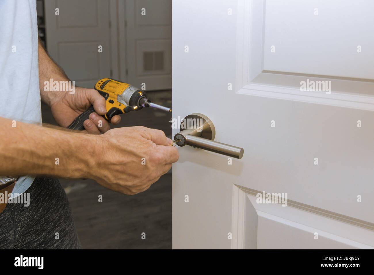 Installation of the door lock interior door woodworker hands install ...