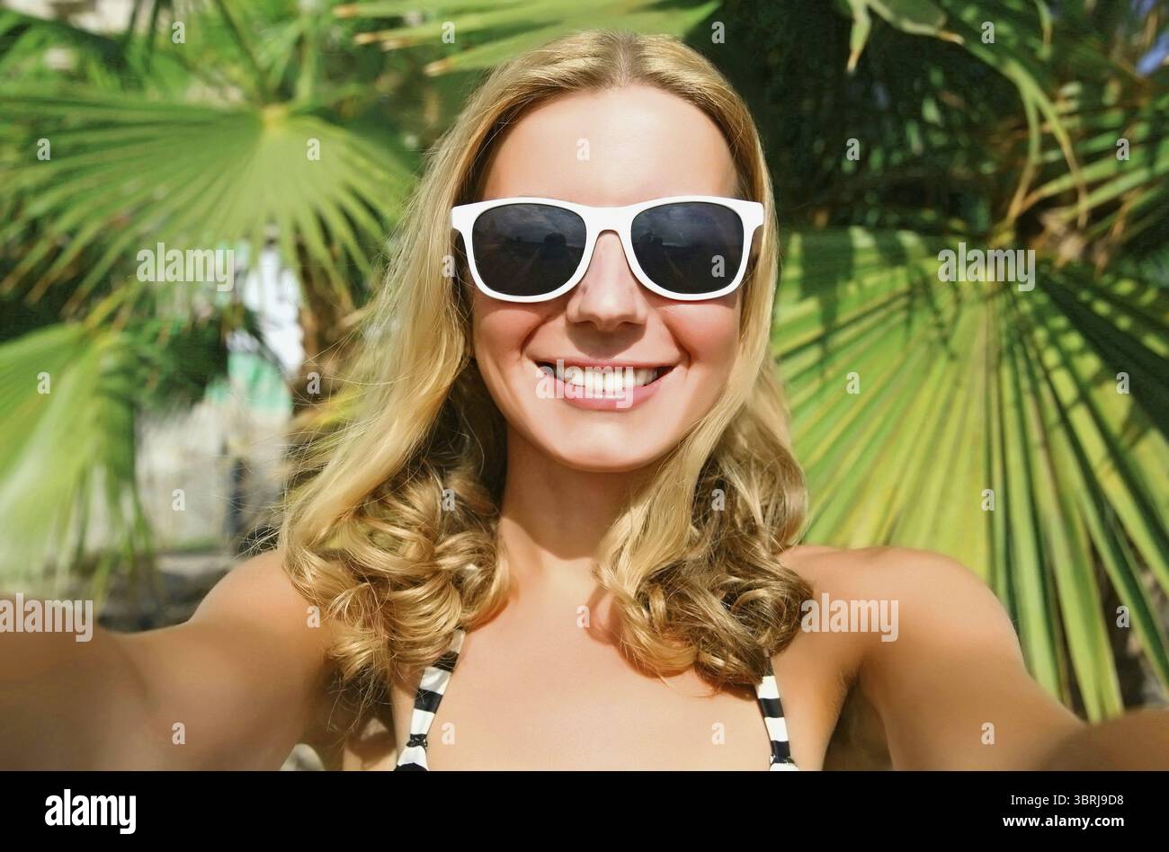 Summer vacation, portrait of happy cheerful smiling young woman ...