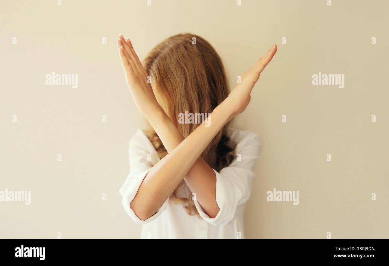 Upset young woman shows stop, no or enough sign with palm of hand ...