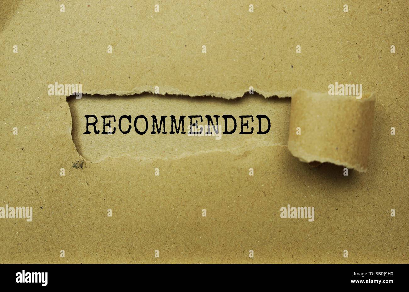 Recommended message written on craft paper with torn paper background ...