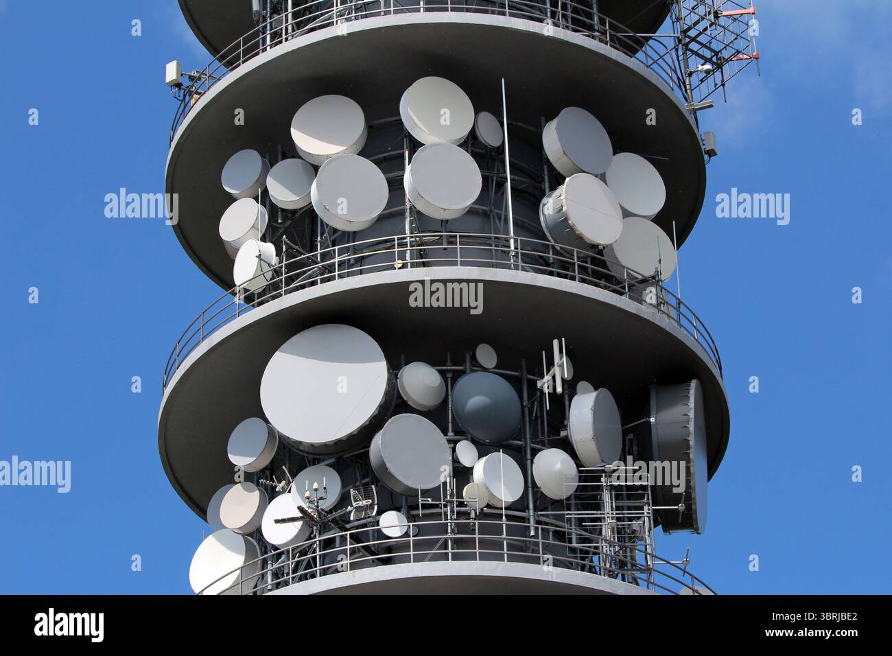 A high-tech telecommunication tower is densely packed with circular ...