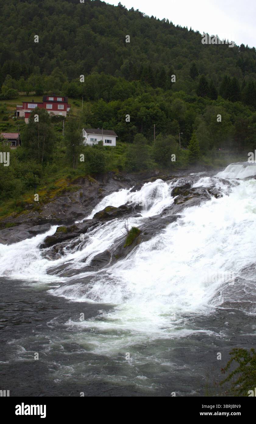 A portrait image of Olden Fjord and Waterfall Stock Photo - Alamy