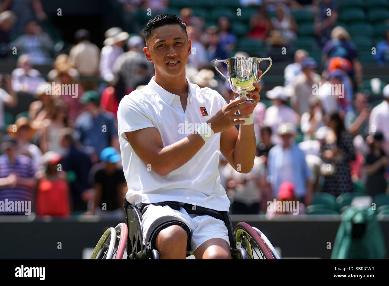 Tokito Oda of Japan holds the trophy after winning the men's wheelchair ...