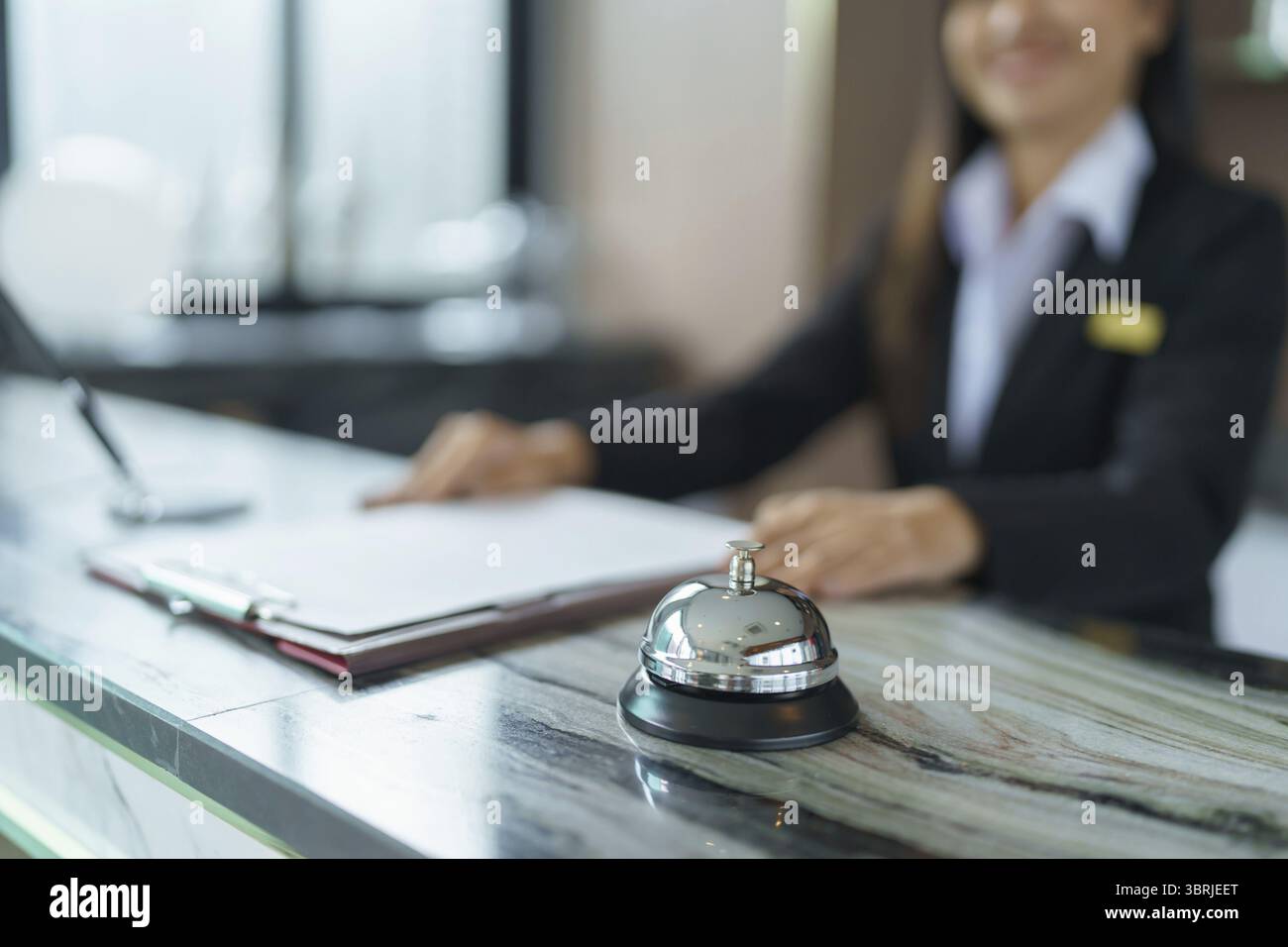 Hotel receptionist in uniforms at desk in lobby Friendly and welcome ...