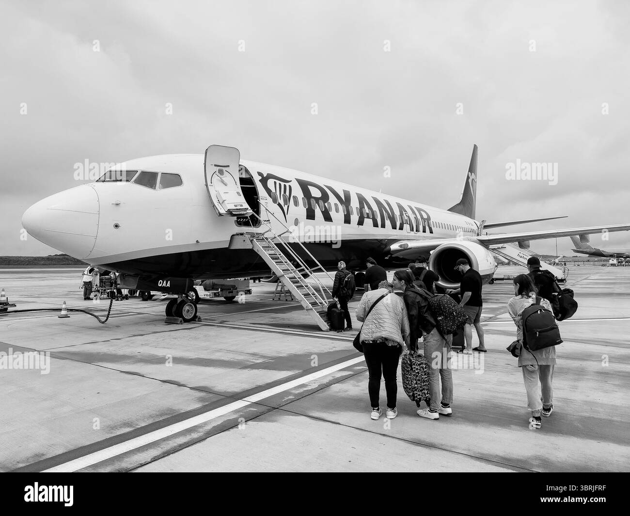 HAHN, GERMANY - JUNE 1, 2025 - Passengers boarding a Ryanair airplane ...