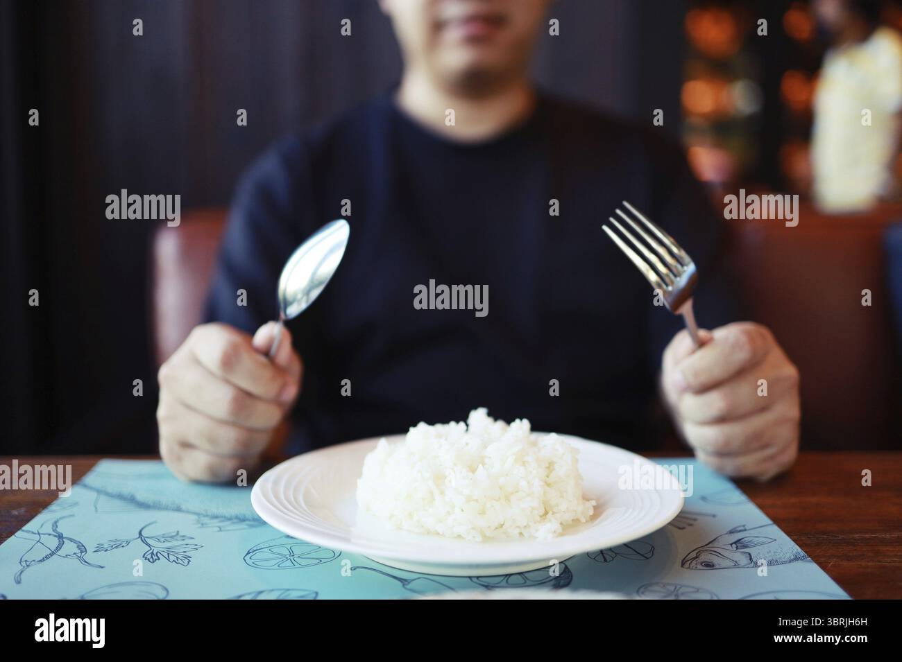 Man eating rice enjoying a meal in restaurant. man having dinner lots ...