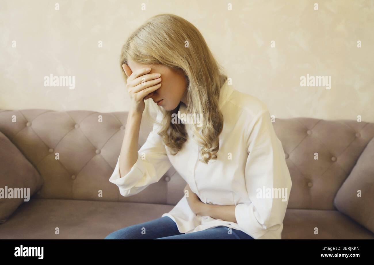 Young woman put hands on abdomen suffering from stomach ache griping ...