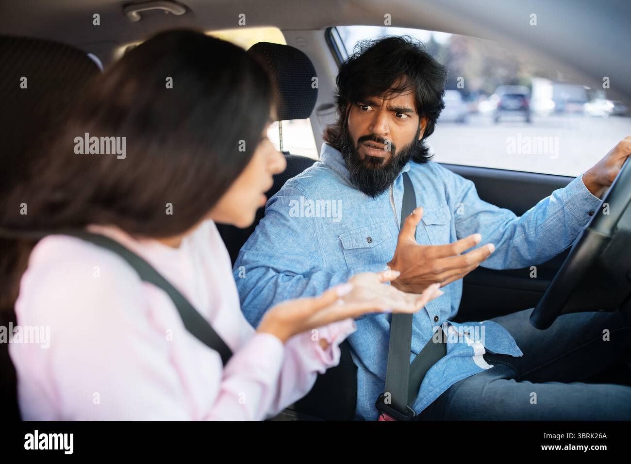 Indian couple arguing inside car with expressive hand gestures Stock ...