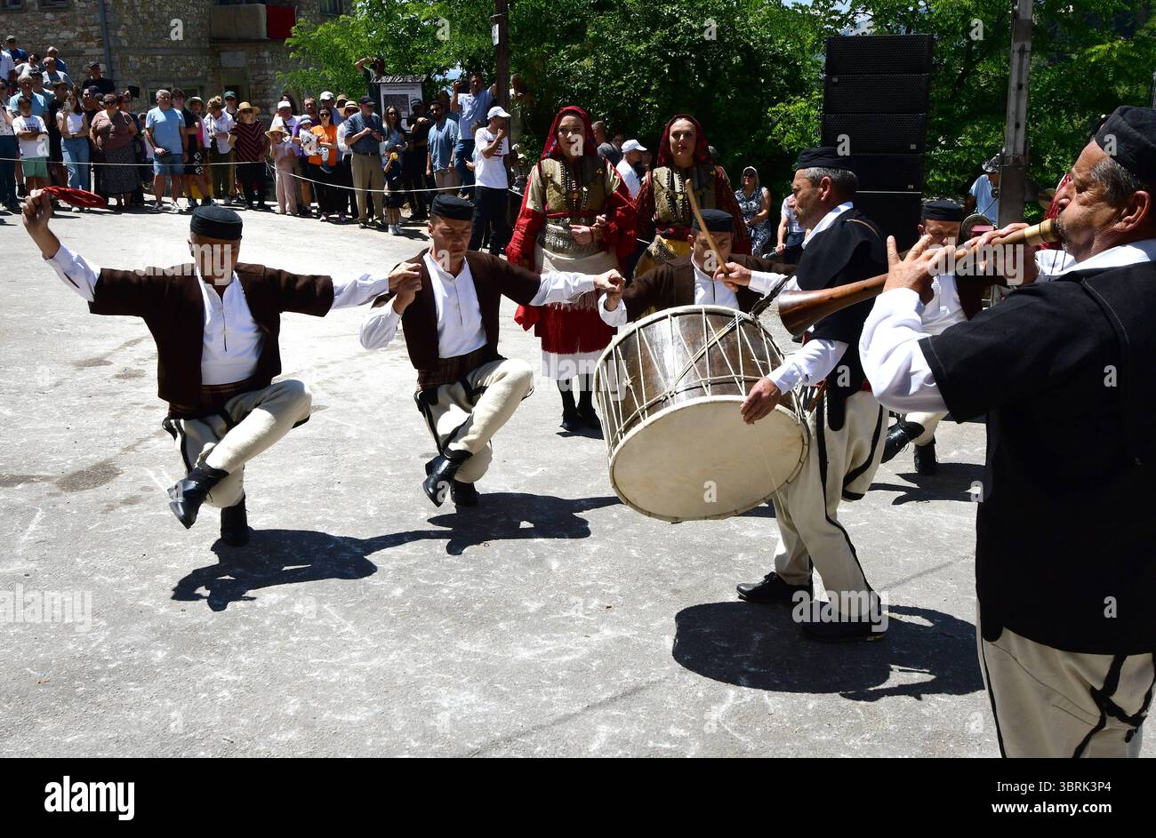 Relatives and dancers dressed in traditional attire dance Macedoinian ...
