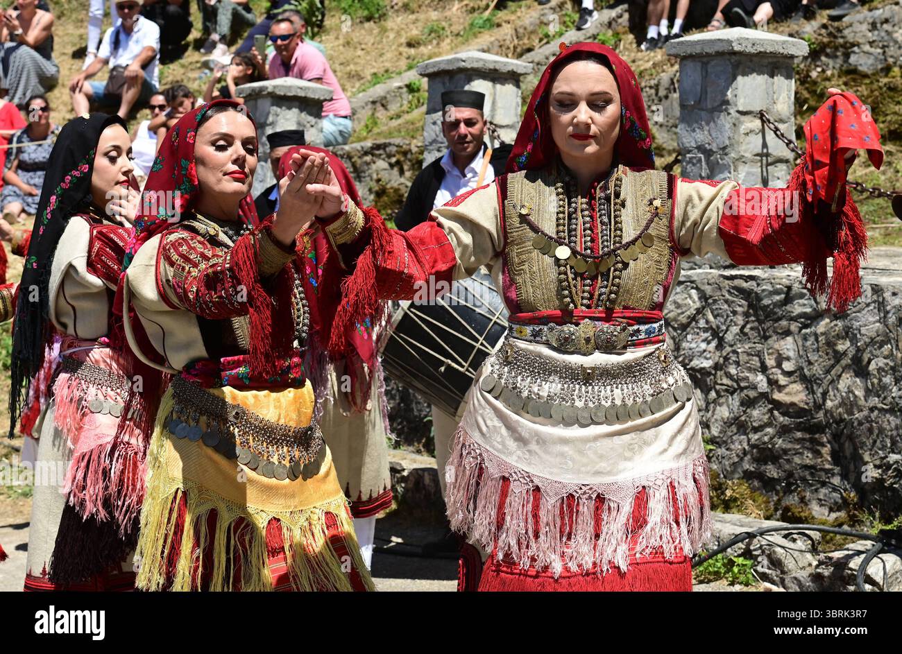 Relatives and dancers dressed in traditional attire dance Macedoinian ...