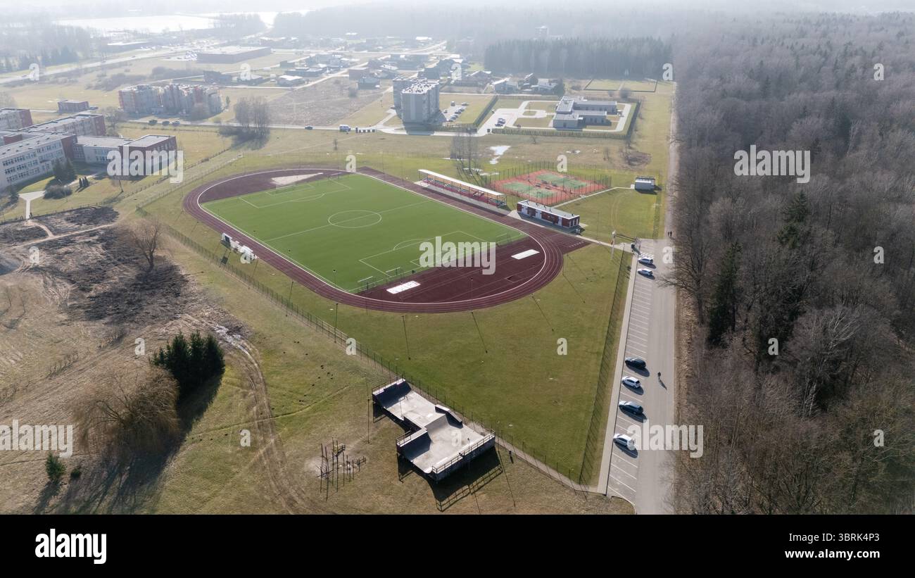Aerial view of a sports complex with a soccer field, running track, and ...