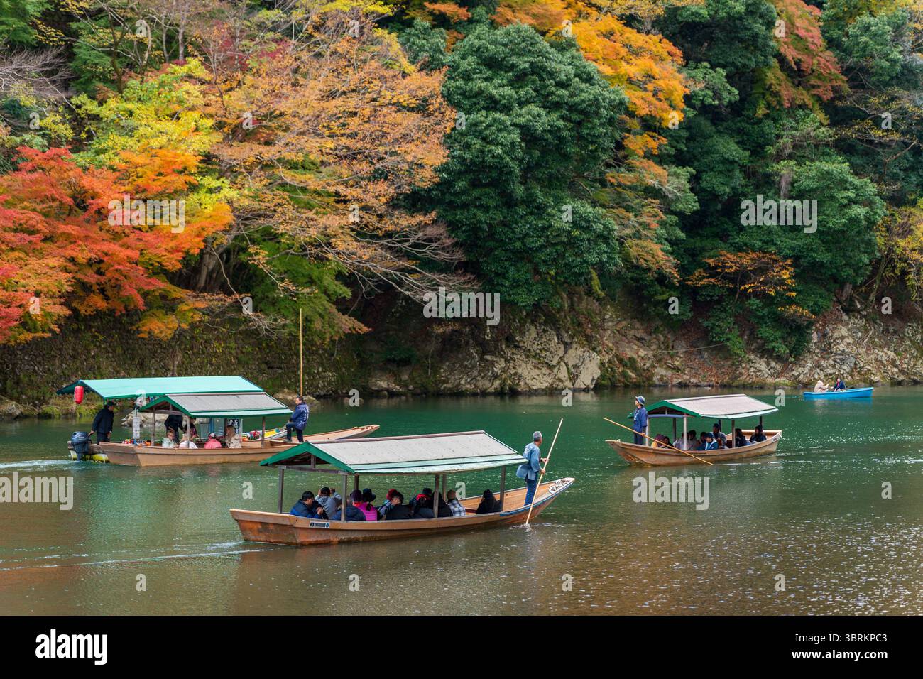 Kyoto, Japan. Tourists enjoy a Yakatabune boat ride on the Oi River and ...