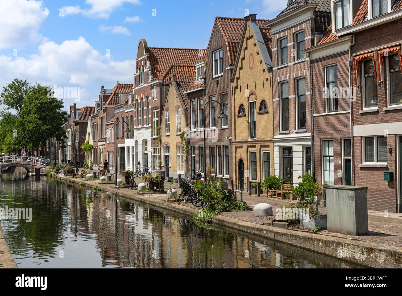 A picturesque canal scene in Gouda, Netherlands, featuring historic ...